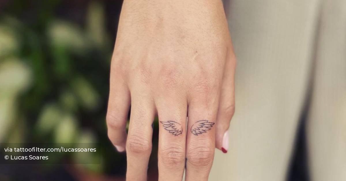 Fine line wings tattooed on the finger