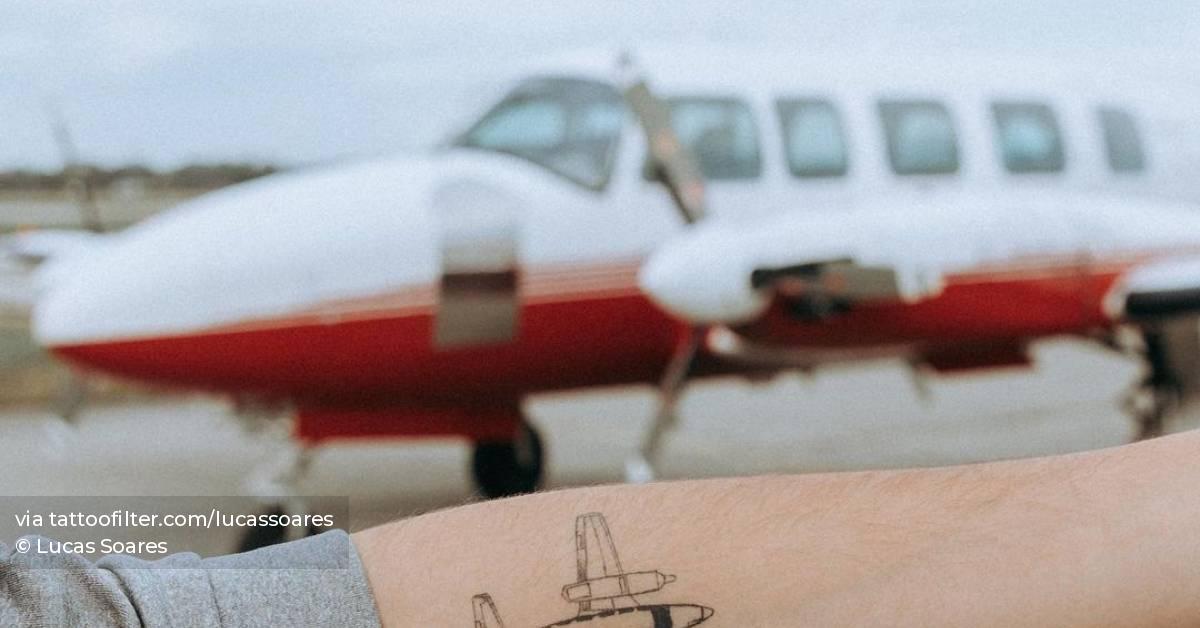 Fine line airplane tattoo on the inner forearm