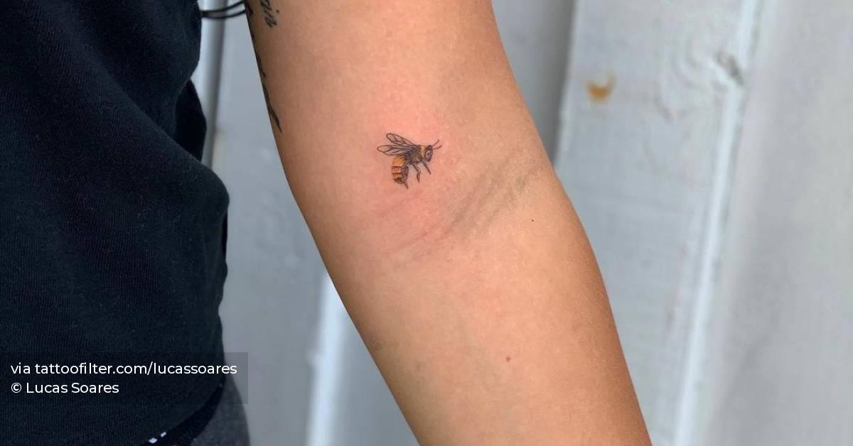 Tiny bee tattoo on the bicep