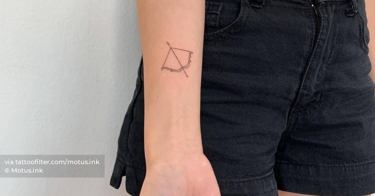 Fine line bow and arrow tattoo on the inner forearm