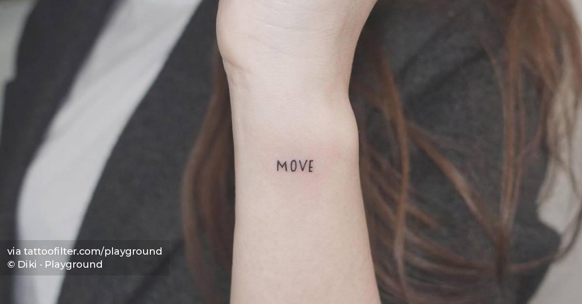 "Move" lettering tattoo on the wrist