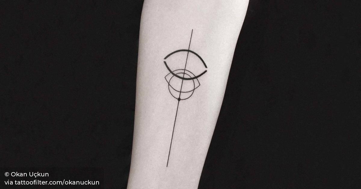 Abstract eye tattoo on the right inner forearm.