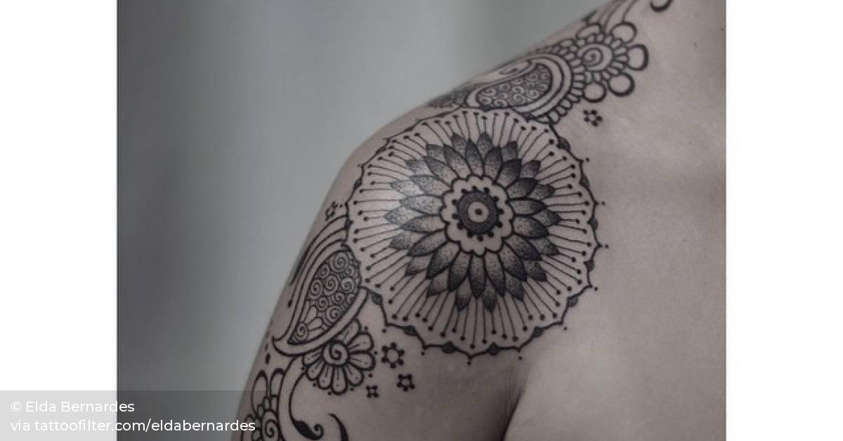 Ornamental style tattoo on the right shoulder.
