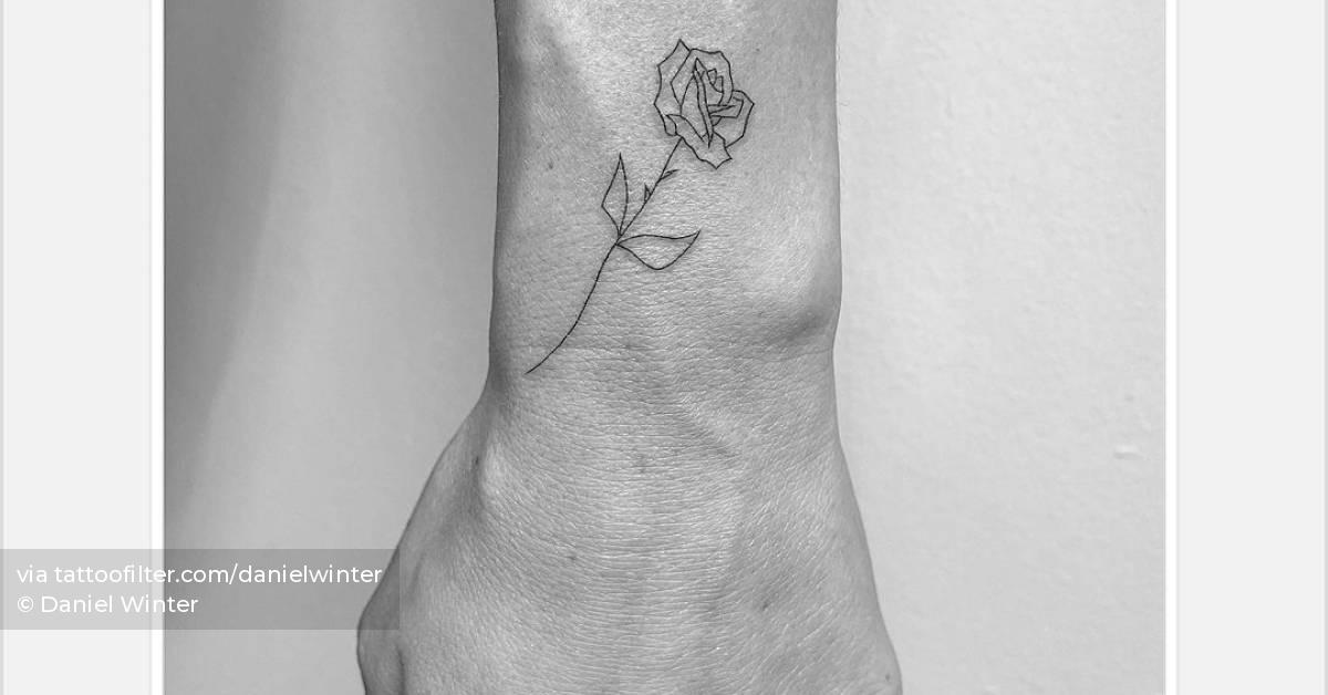 Fine line rose tattoo on the wrist
