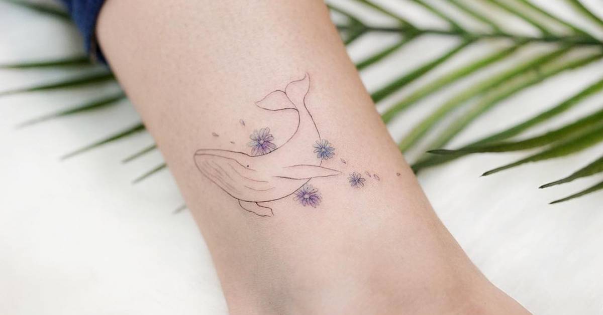 Fine line whale tattoo on the ankle