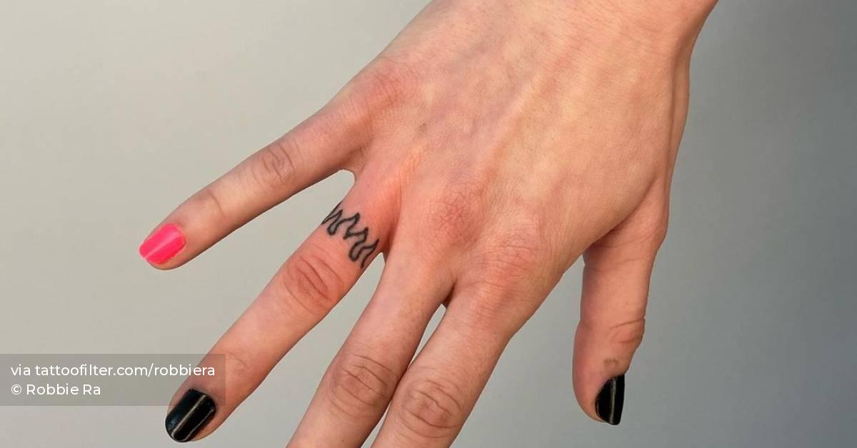 Hand poked fire tattoo on the finger