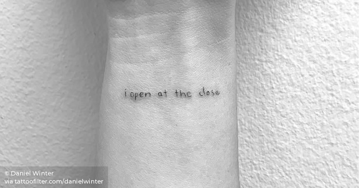 “I open at the close” tattoo on the wrist.