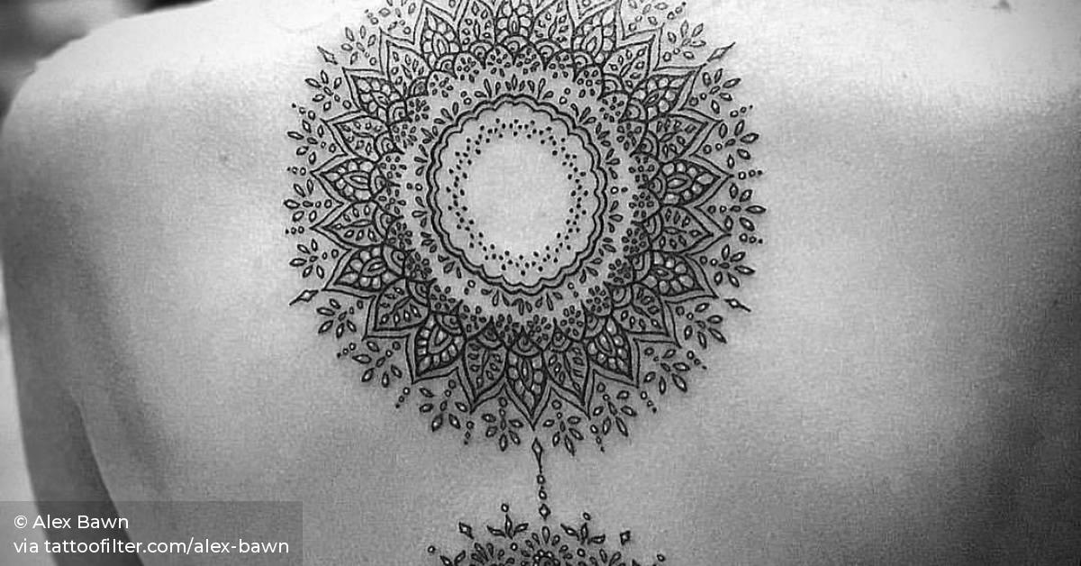 Mandala tattoos on the back.