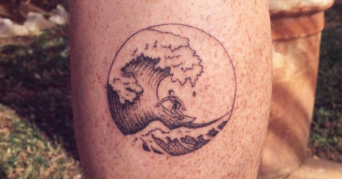 Hand poked big wave surfer tattoo on the calf.