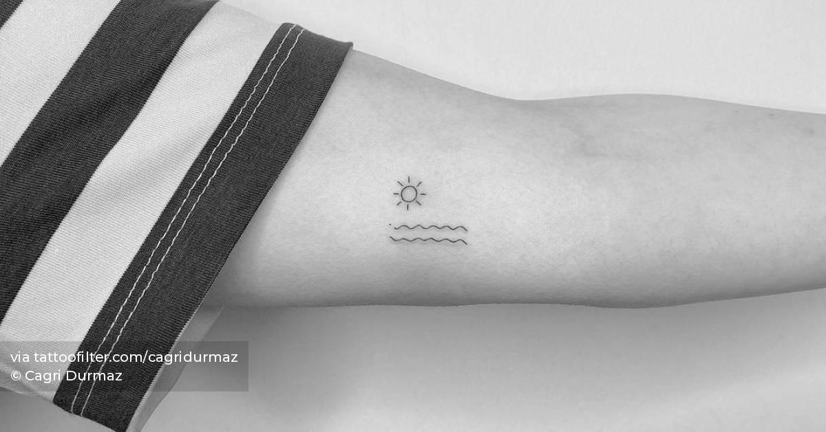 Minimalist sun and wave tattoo on the inner arm.