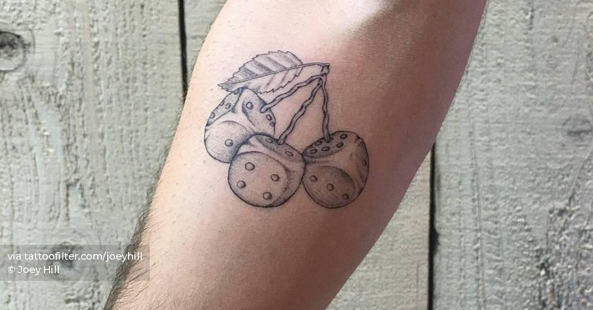 Fine line cherry dice tattoo on the inner forearm.
