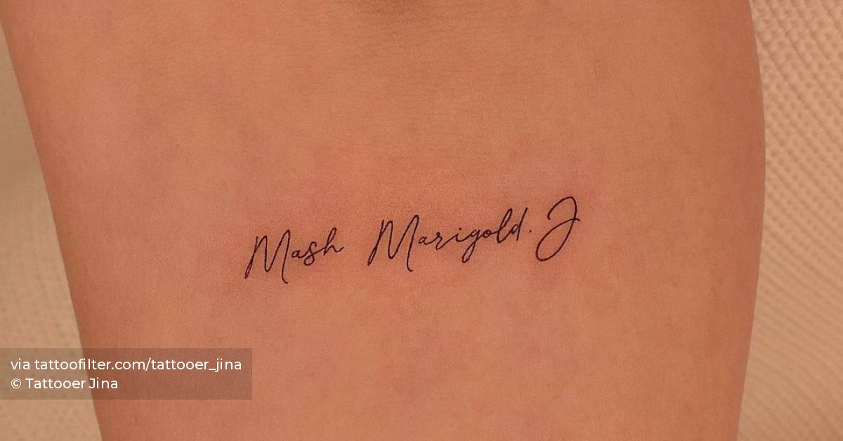 "Mash Marigold" lettering tattoo on the inner forearm.