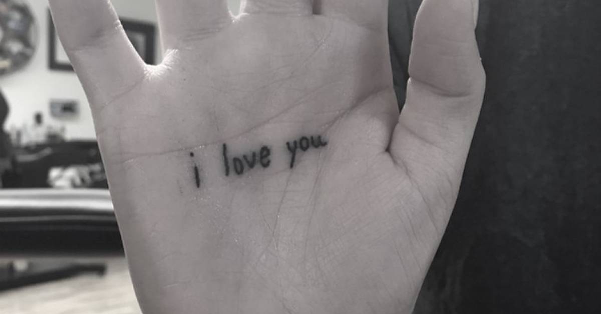 "I love you" lettering tattoo on Julia Michael's palm.