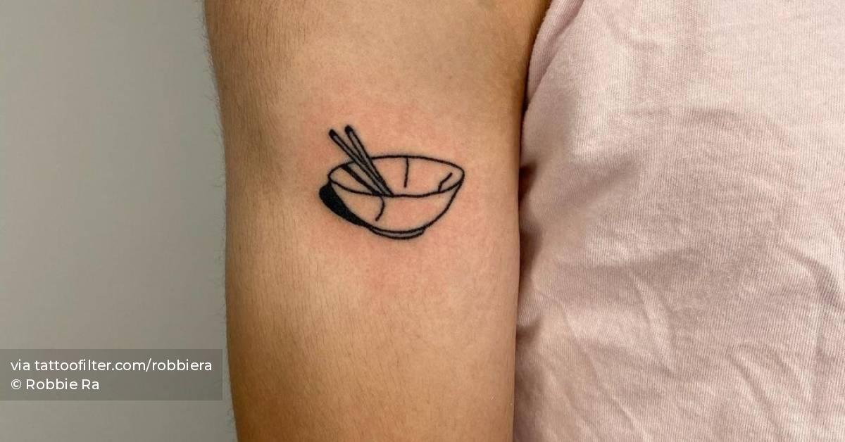 Hand poked ramen bowl tattoo on the upper arm.