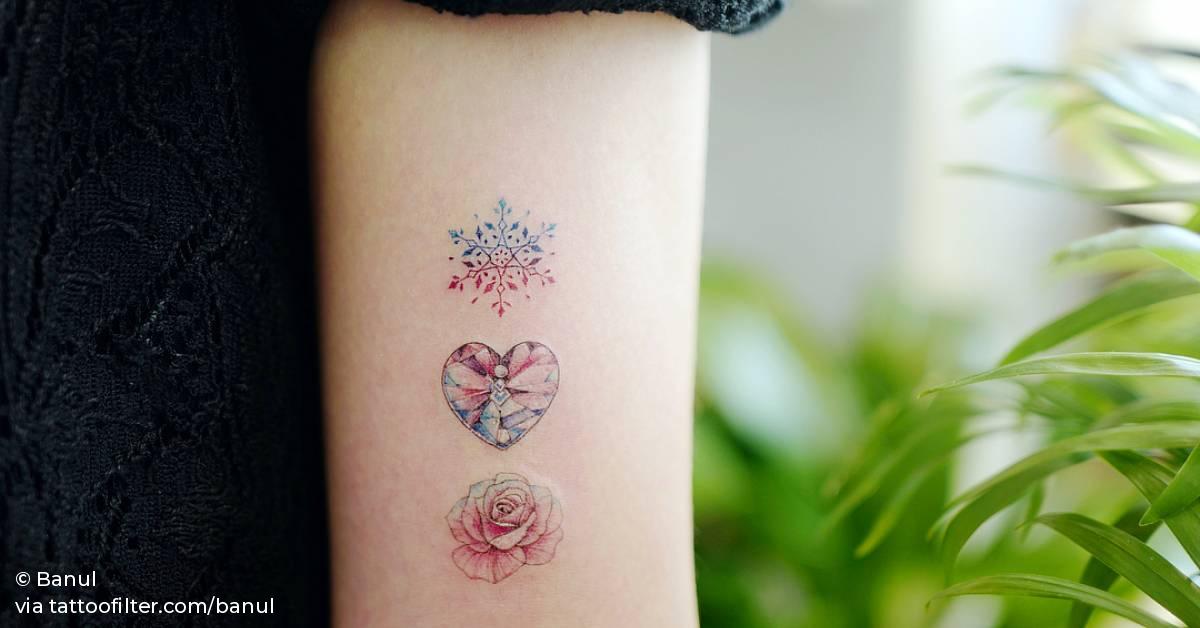 Snowflake, heart shaped gem and rose tattoo on the