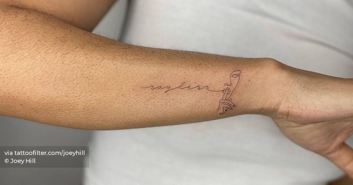 "Say less" lettering tattoo on the wrist.