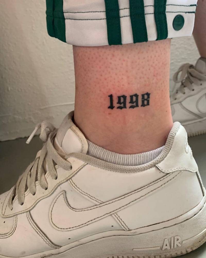 1998 Lettering Tattoo On The Ankle 1998 Lettering Tattoo On The Ankle