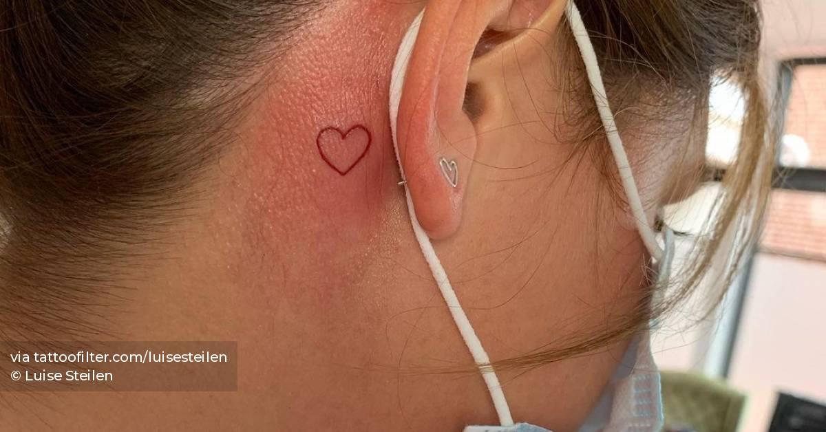 Minimalist heart tattoo behind the ear.
