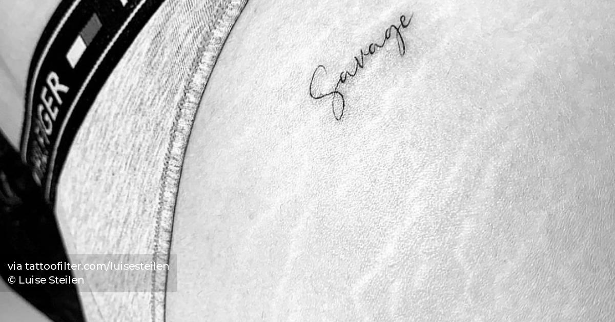 "Savage" lettering tattoo on the hip.