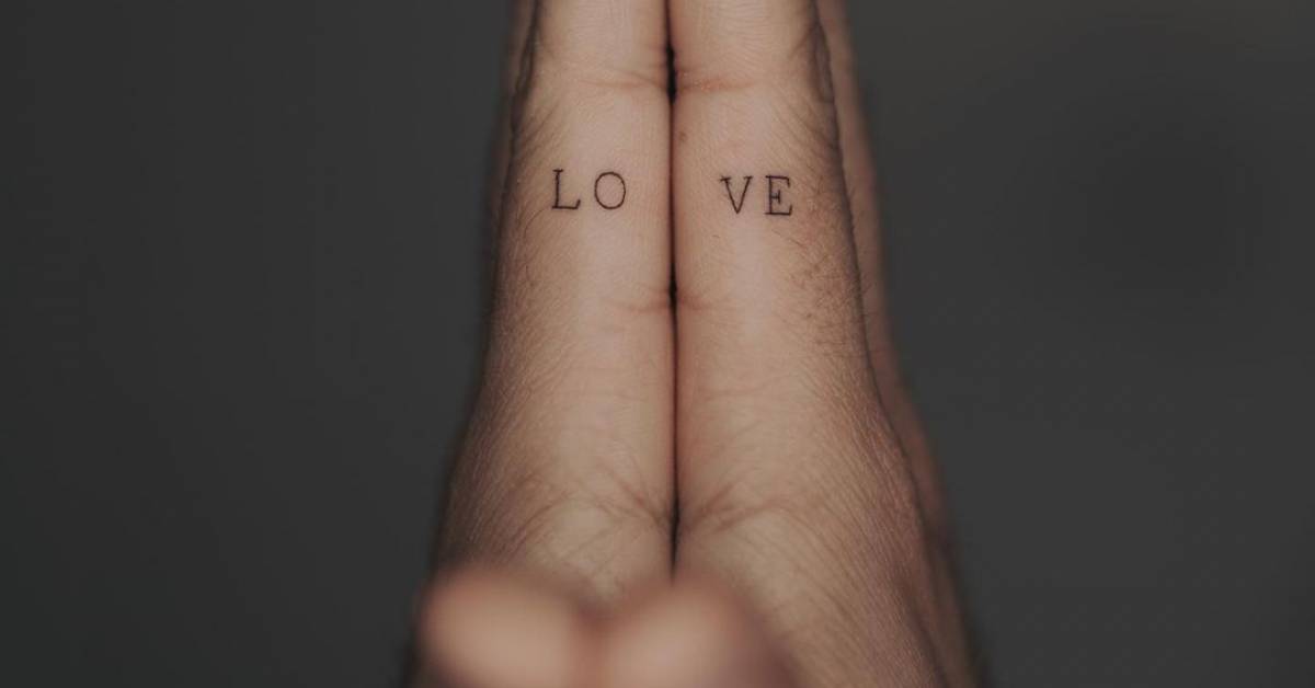 Individual matching "LOVE" lettering tattoo on the