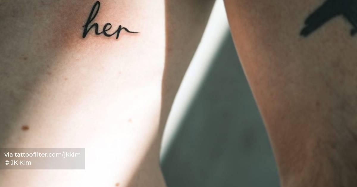 "Her" lettering tattoo on the inner arm.