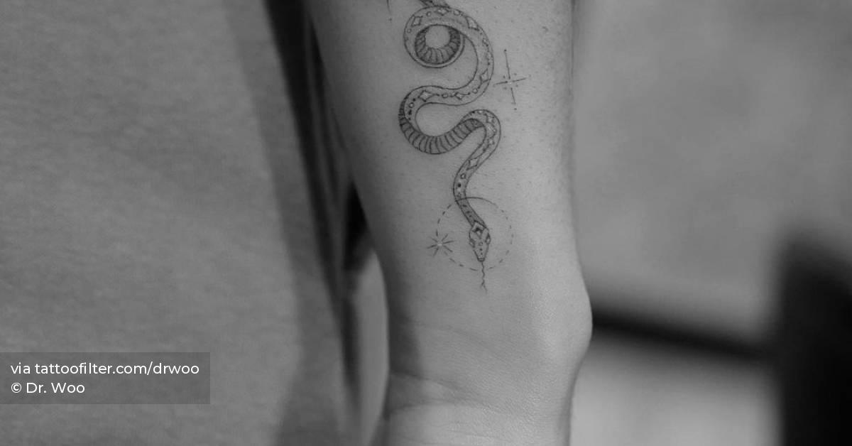 Single needle snake tattoo on the Sydney Park's wrist.