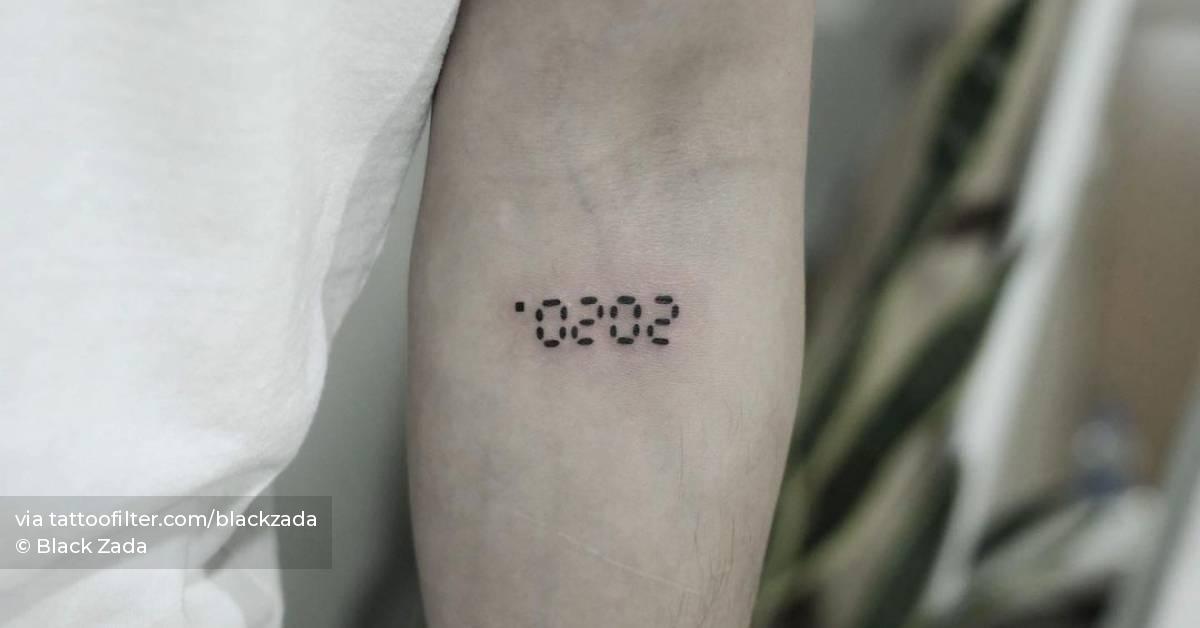 "2020" lettering tattoo on the inner forearm