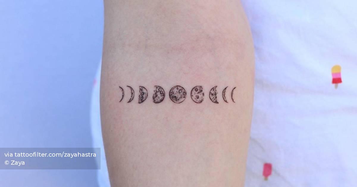 Fine line moon phases tattoo on the inner forearm.
