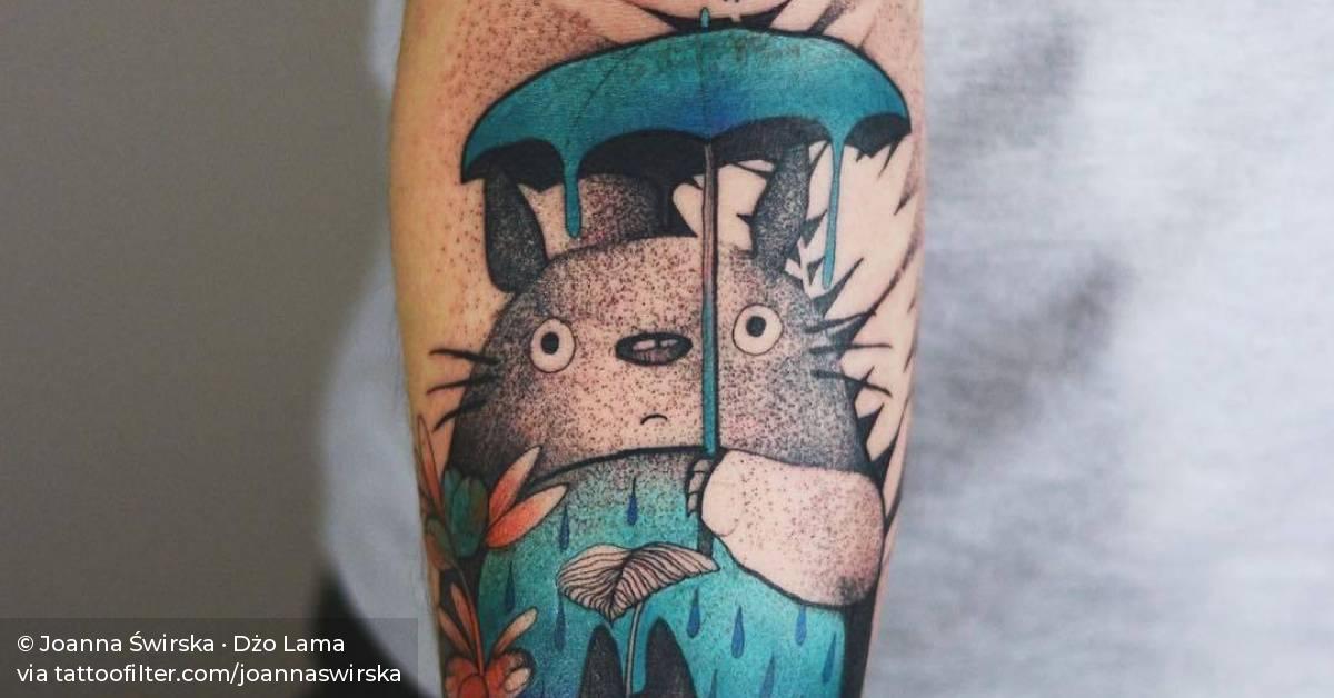 Totoro tattoo on the right inner arm.