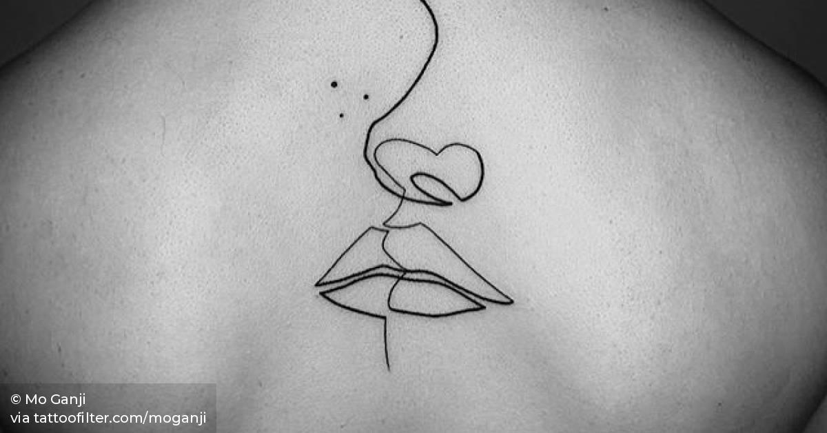 Continuous line minimal face tattoo on the upper back.