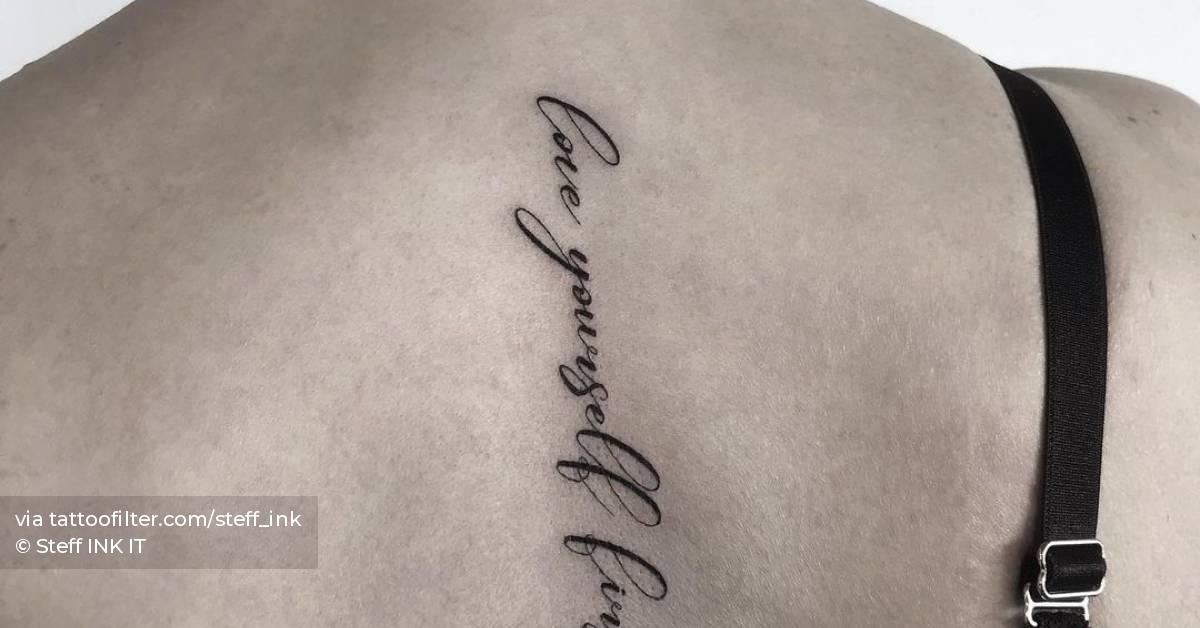 "Love yourself first" lettering tattoo on the upper