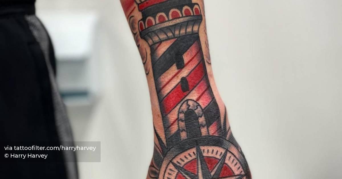 Traditional style lighthouse and compass tattoo on the