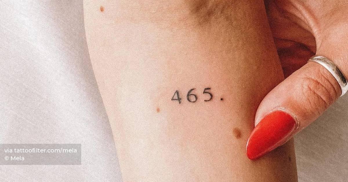 "465" lettering tattoo on the inner forearm.