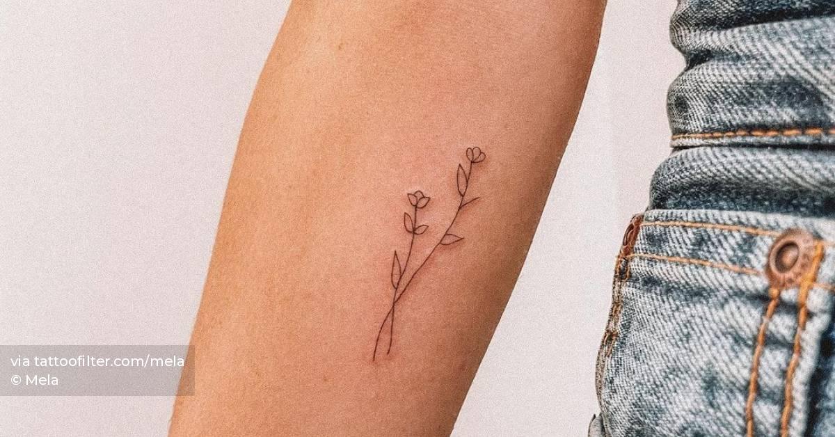 Fine line flowers tattoo on the inner forearm.