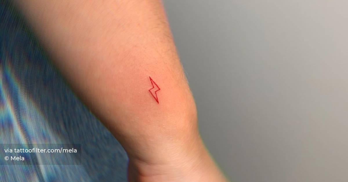 Minimalist lighting bolt tattoo in red ink.