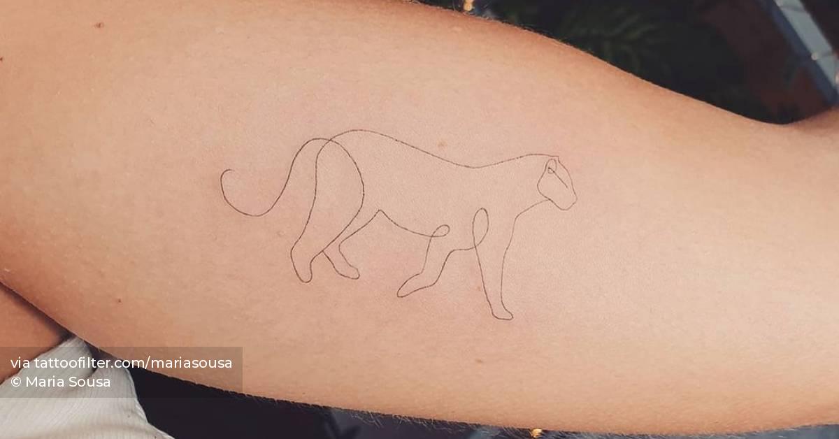 One line leopard tattoo on the inner arm.