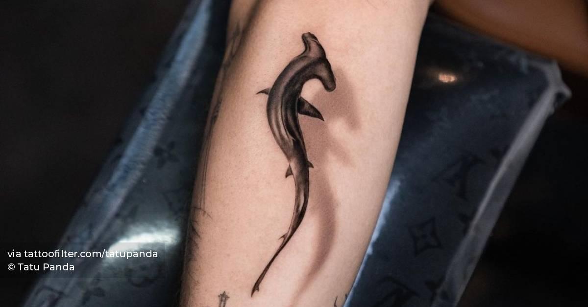 Micro-realistic hammerhead shark tattoo on the forearm.