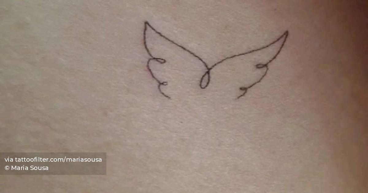 Minimalist wings tattoo on the rib.