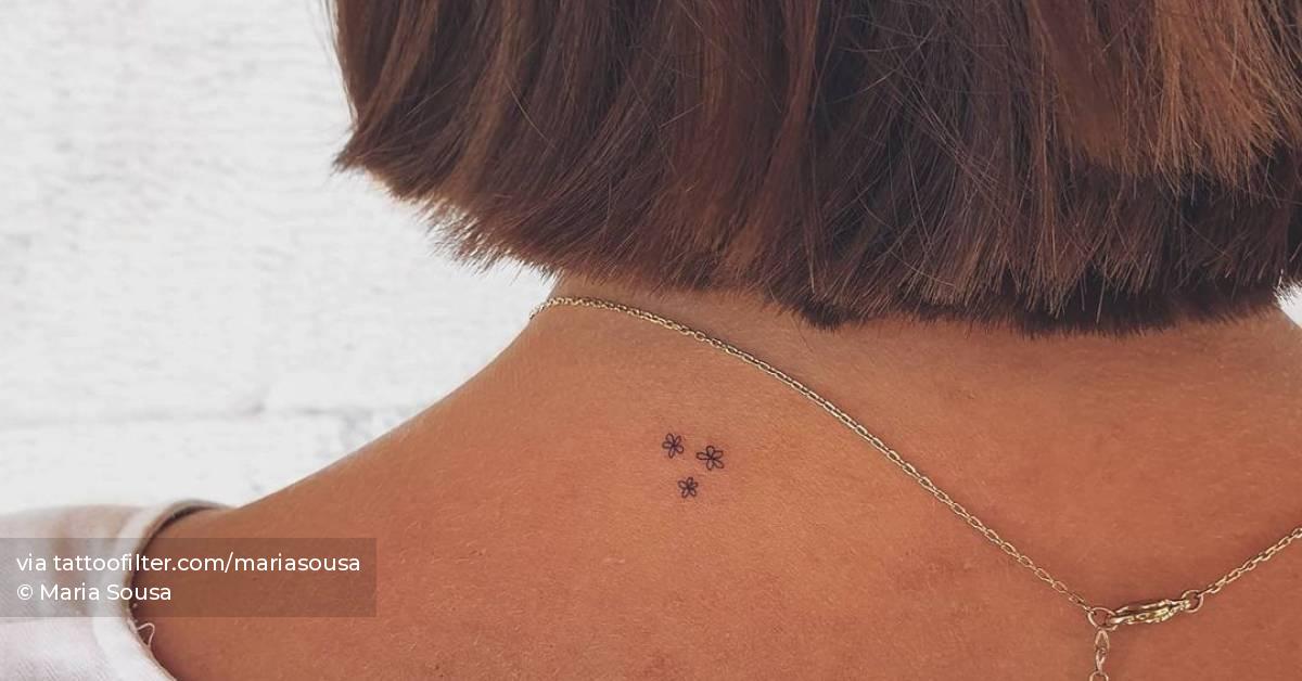 Minimalist flowers tattoo on the upper back.