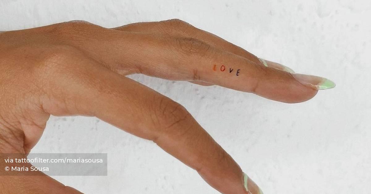 "Love" lettering tattoo on the finger.