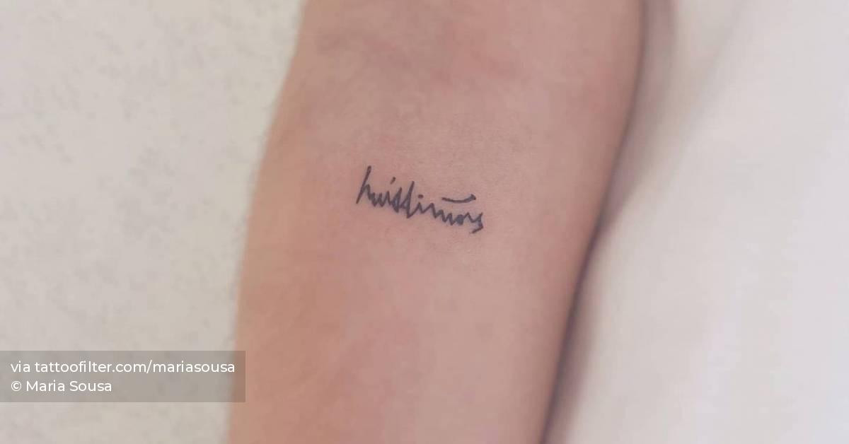 Signature tattoo on the inner forearm.