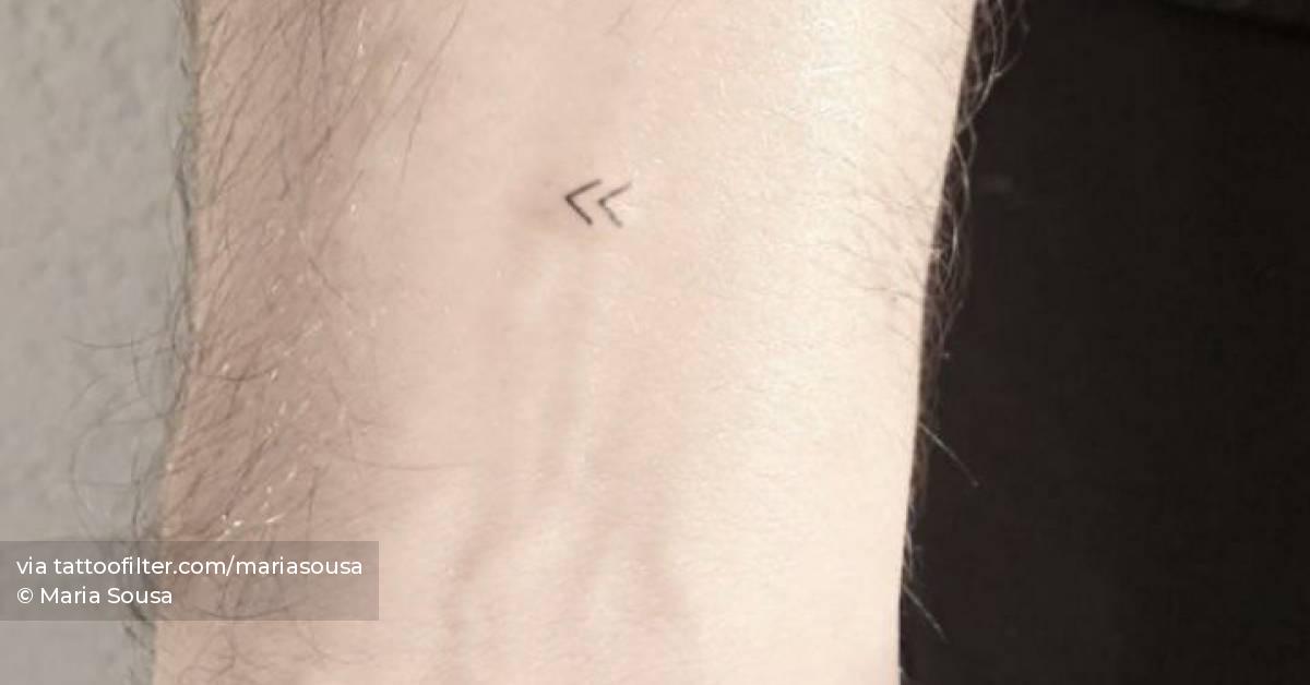 Minimalist fast forward symbol tattoo on the wrist.