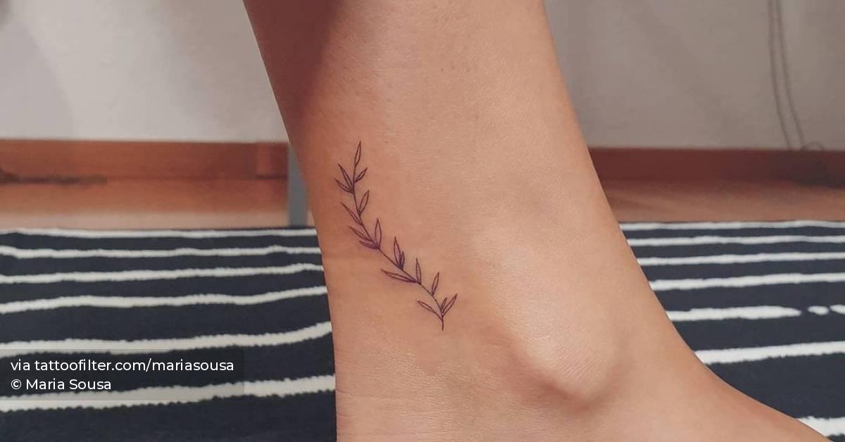 Minimalist sprig tattoo on the ankle.
