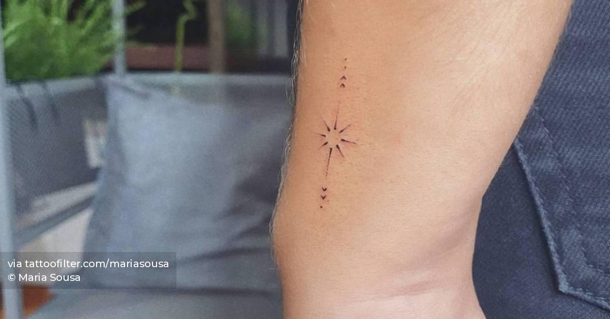 Minimalist star tattoo on the wrist.
