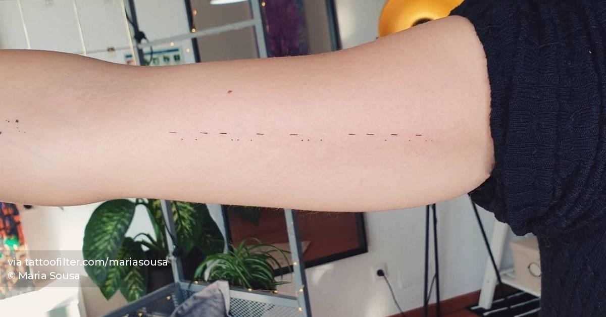 Minimalist morse code tattoo on the inner arm.
