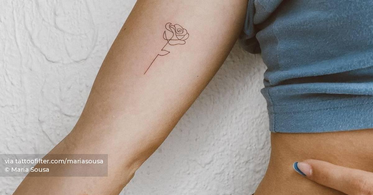 One line rose tattoo on the inner arm.