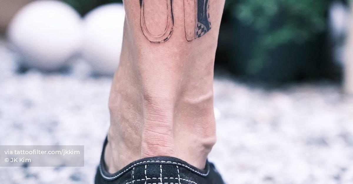 Micro-realistic Vans Slip-On tattoo on the achilles.
