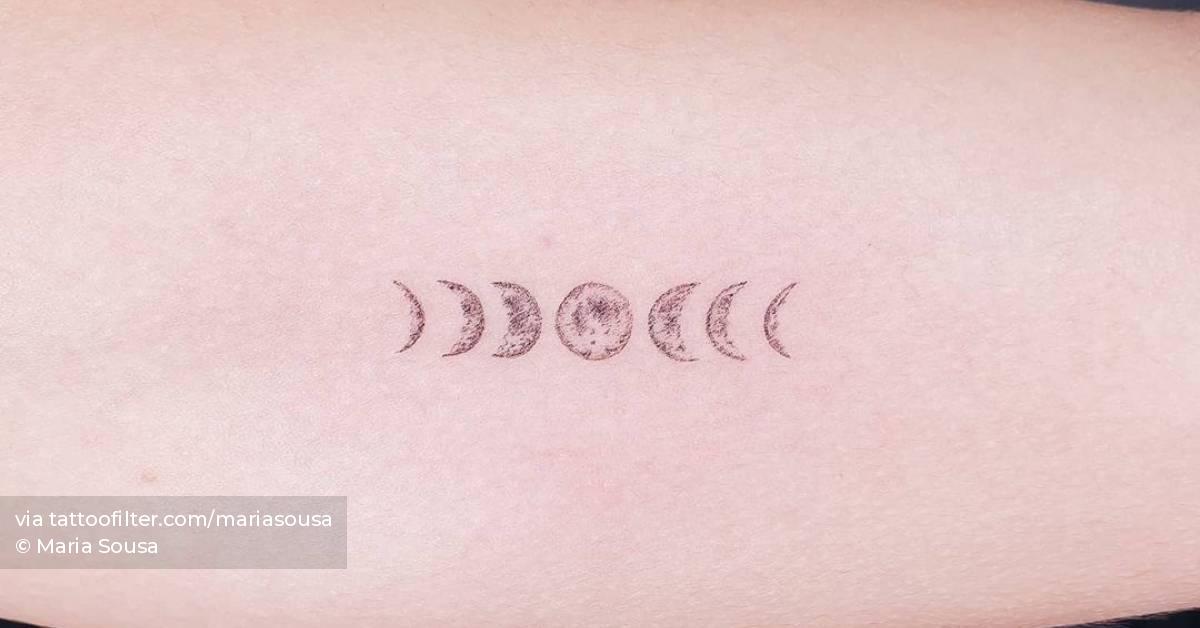 Fine line moon phases tattoo on the inner arm.