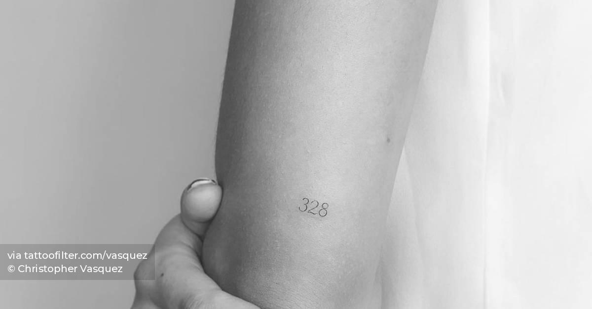Number "328" tattoo on the tricep.