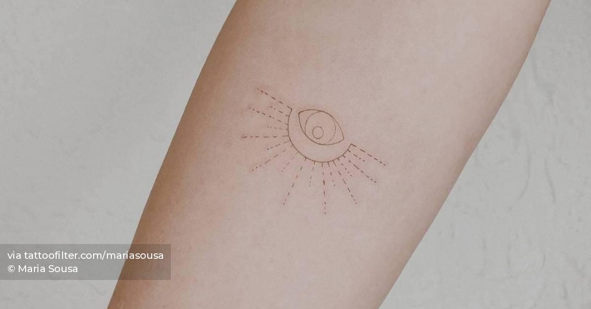 Fine line sunset and eye tattoo on the inner forearm.